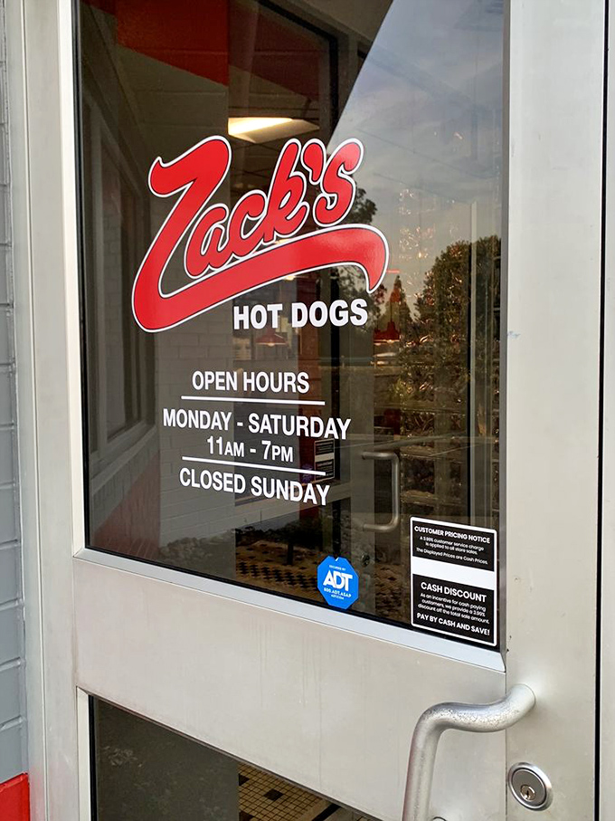 The hours posted on the door—vital information for planning your pilgrimage to this North Carolina hot dog sanctuary.