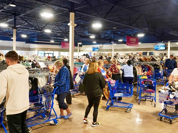 Blue carts filled with potential treasures navigate the aisles. The weekend crowd knows Saturday mornings offer first dibs on fresh inventory.
