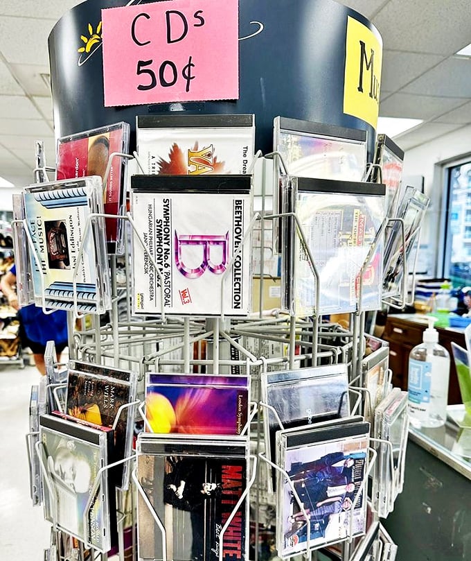 The CD carousel of nostalgia spins with 50-cent memories. Before streaming existed, these plastic discs were how we shared our musical personalities.