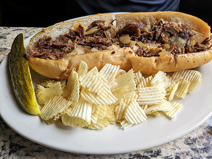The cheesesteak that launched a thousand napkins. Tender beef, melted cheese, and a pickle standing guard like it knows something we don't.