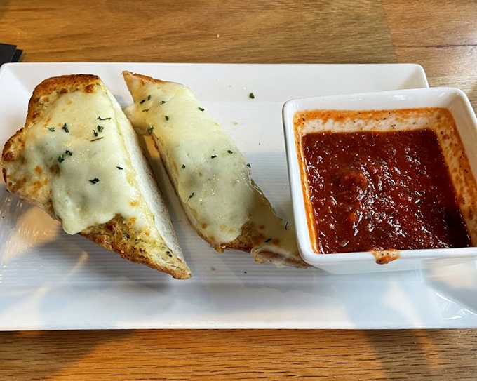 Cheesy garlic bread that makes you forget your table manners – crispy, gooey, and perfect for marinara dipping.