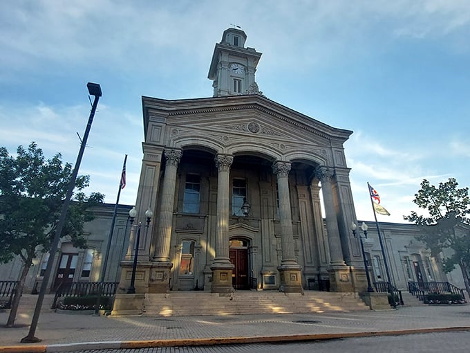 The Ross County Courthouse stands majestically at dusk, its columns and clock tower illuminated&mdash;a beacon of small-town governance where decisions affect neighbors, not numbers.