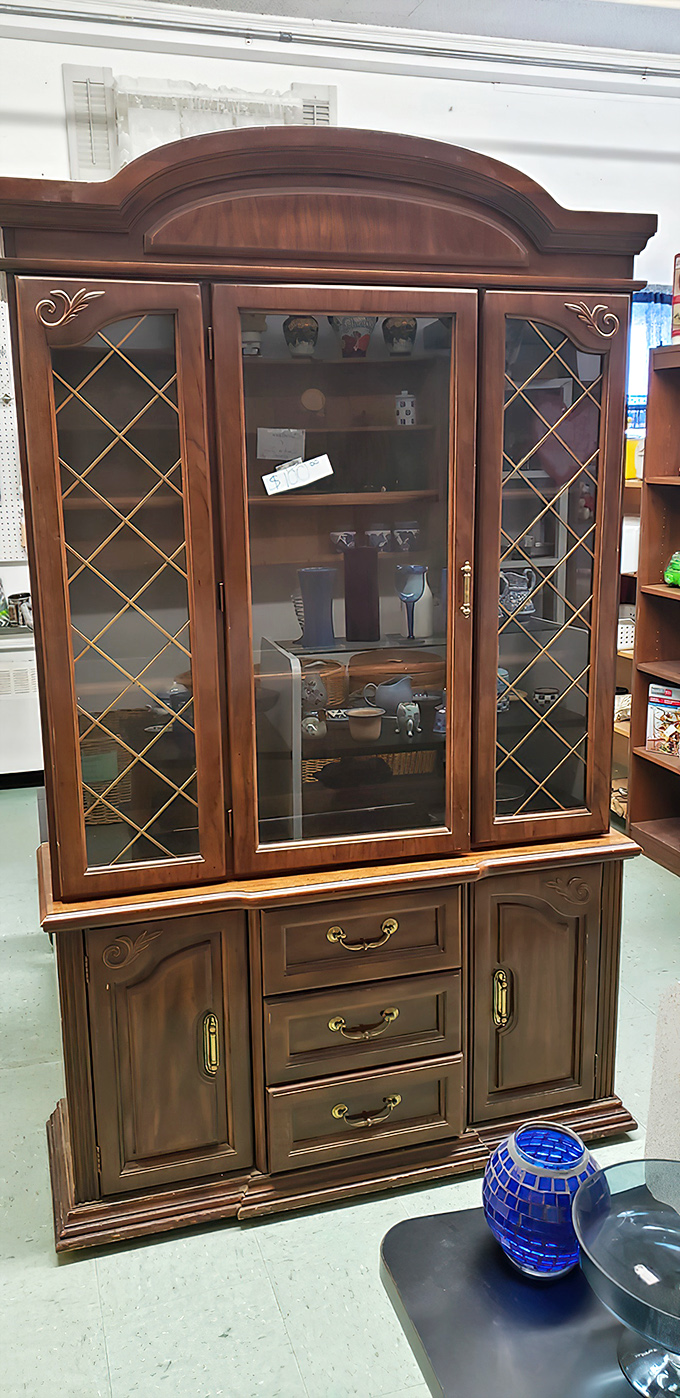 This china cabinet isn't just furniture; it's architectural heritage waiting to display your grandmother's teacups or your quirky mug collection.
