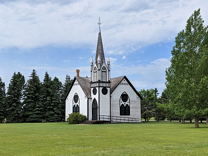 The historic Vikur Lutheran Church stands as an elegant sentinel of faith and heritage. Its white spire reaches skyward like a prayer made permanent.