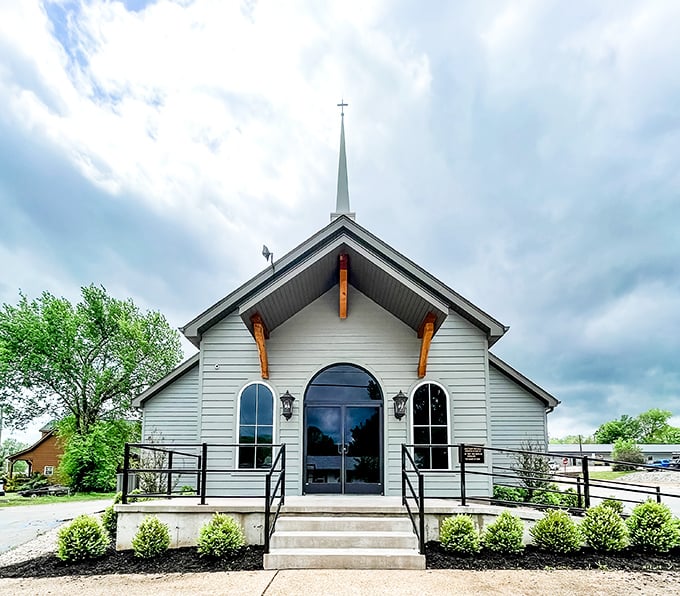 The white church stands sentinel under dramatic skies, its simple architecture a reminder of the spiritual foundations that anchor many small Midwestern communities.