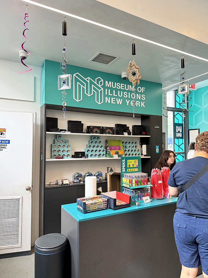 The museum's counter area features the signature teal branding and plenty of brain-teasing souvenirs to continue the illusion experience at home.