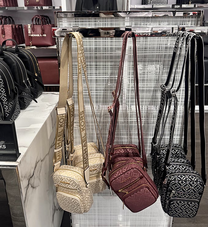 Michael Kors crossbody bags hanging like ripe fruit, ready to be plucked by savvy shoppers with excellent taste and reasonable budgets.