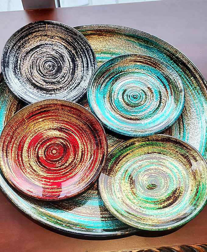 These swirling, colorful plates look like they spun right off a potter's wheel and into your dining room fantasies.