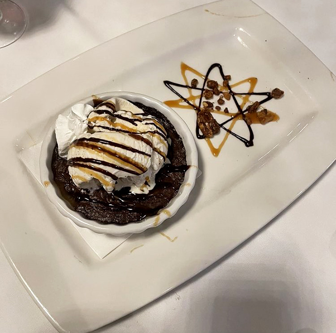 A chocolate dessert that's clearly been told it's the star of the show. That whipped cream and caramel drizzle are just showing off at this point.