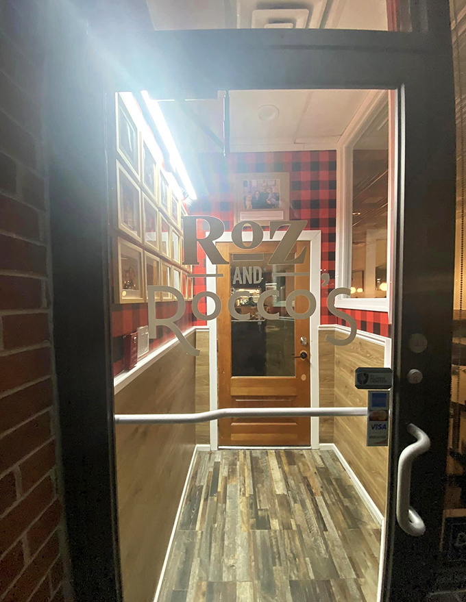 The entrance beckons with warm lighting and that red buffalo plaid wallpaper&mdash;like walking into the coziest Italian dinner party you've ever been invited to.