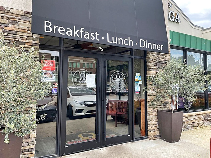 The entrance beckons with stone accents and simple signage—"Breakfast • Lunch • Dinner"—three little words that promise so much deliciousness inside.