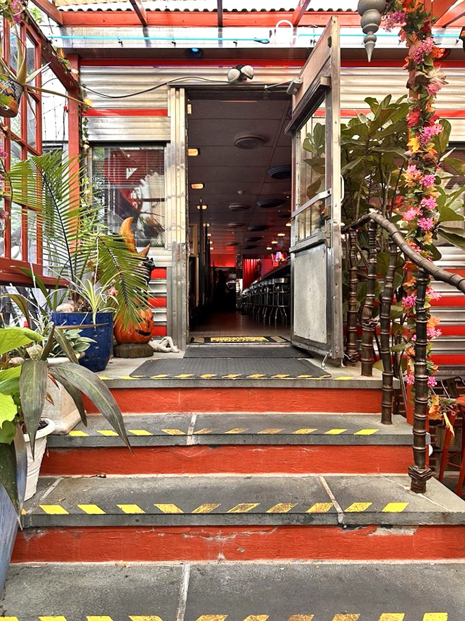 An entrance that promises adventure – framed by lush plants and beckoning you into a world where everyday dining becomes an extraordinary experience.