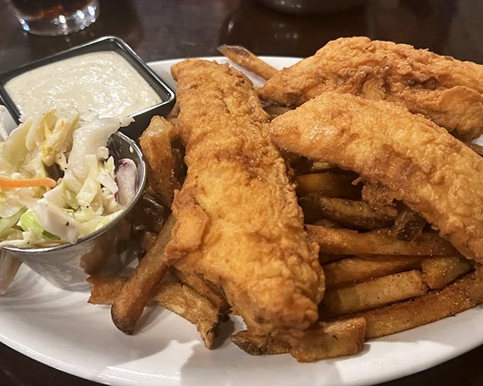 Fish and chips that would make a British pub jealous. The golden batter crackles with each bite, revealing the tender white fish hiding within.