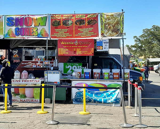 Snow cones and loaded hot dogs compete for attention at this food stand, where summer refreshment meets guilty pleasure in perfect harmony.
