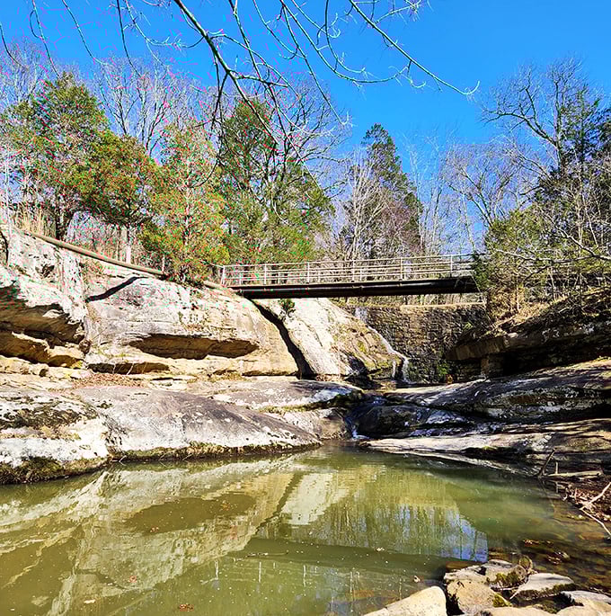 Where geology meets engineering. This footbridge offers both passage across the stream and the perfect vantage point for contemplating life's deeper questions.