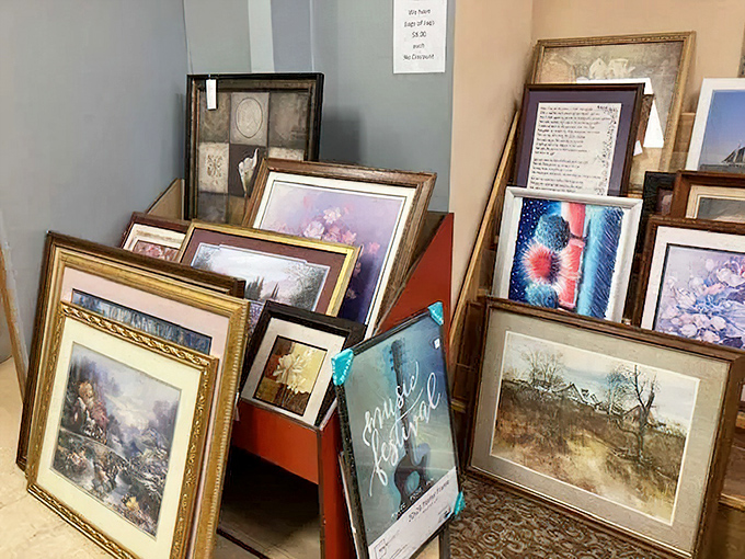 Framed art leaning against walls, each piece waiting to become the focal point of someone's freshly decorated room.