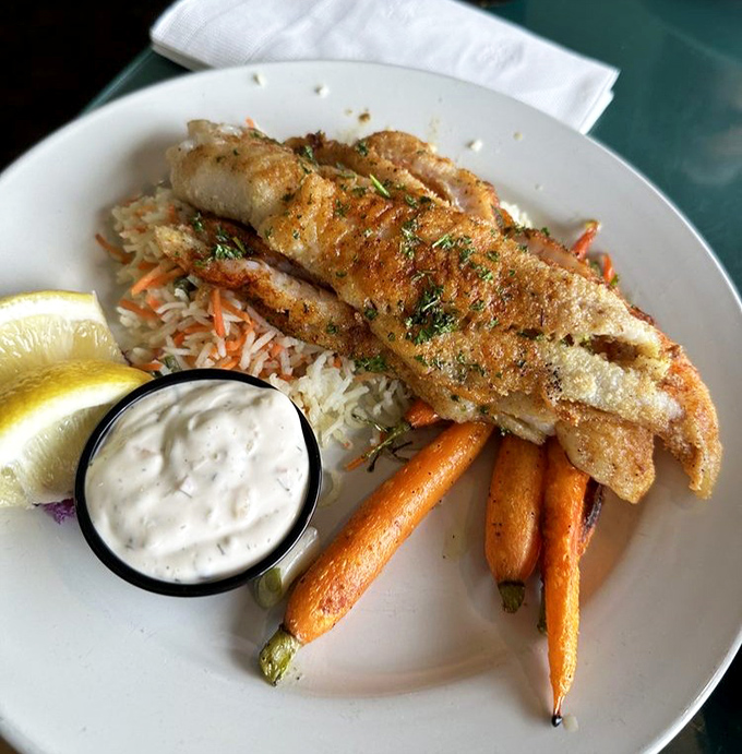 Fresh cod doesn't get fresher than this—perfectly golden and perched atop rice like it just decided to take a delicious vacation from the sea.