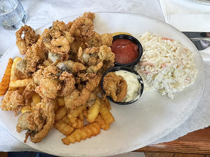 Fried clams with golden jackets so crisp they practically snap, served with the holy trinity of fries, slaw, and dipping sauces.