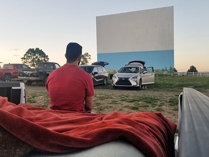 The ultimate movie seat: a truck bed transformed into a cozy nest of blankets, the perfect vantage point for big-screen adventures.
