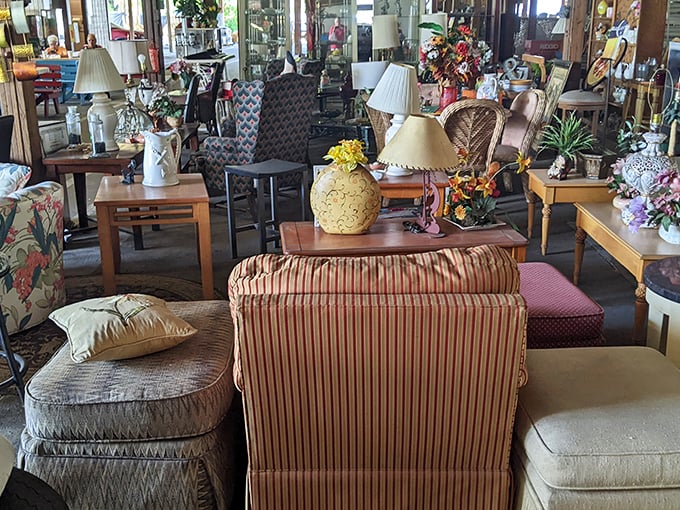 A furniture vendor's display resembles a living room frozen in time, waiting for someone to bring these pieces back to life.
