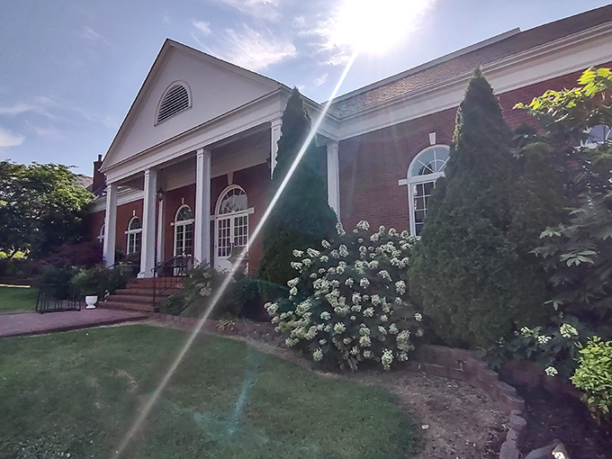 The Greene County Public Library welcomes knowledge-seekers with classic columns and sunlit charm. Books just read better in beautiful buildings like this.