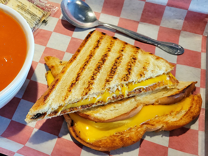 The humble grilled cheese elevated to art form. That cheese pull could win Olympic medals, and the tomato soup is the perfect dance partner.