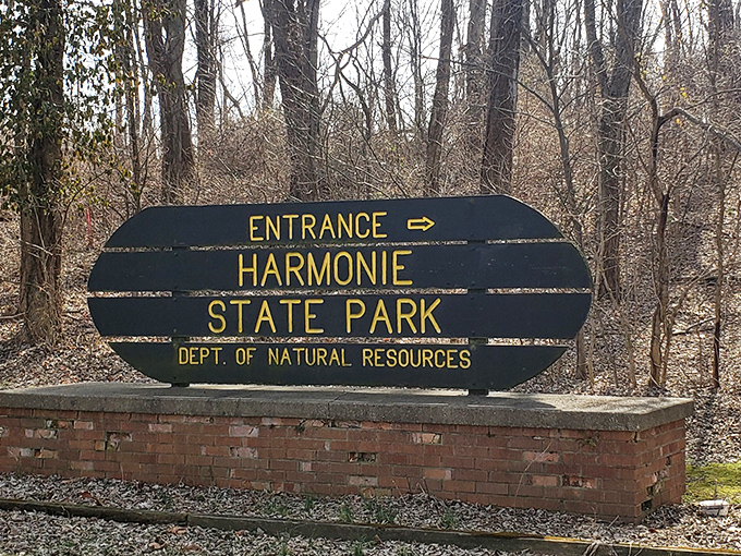 The unassuming entrance sign stands as a portal between everyday life and the natural sanctuary that awaits beyond.