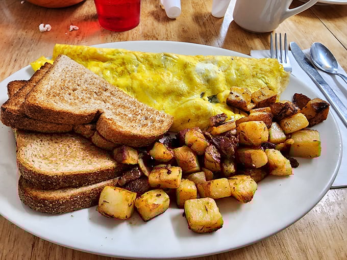 The perfect omelet alongside home fries that achieve the golden-brown perfection we all attempt but rarely achieve at home.