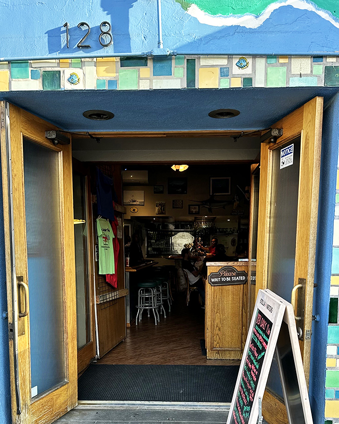 The entrance to seafood paradise, framed by colorful tiles and wooden doors. Like the wardrobe to Narnia, but instead of a lion, you'll find lobster.