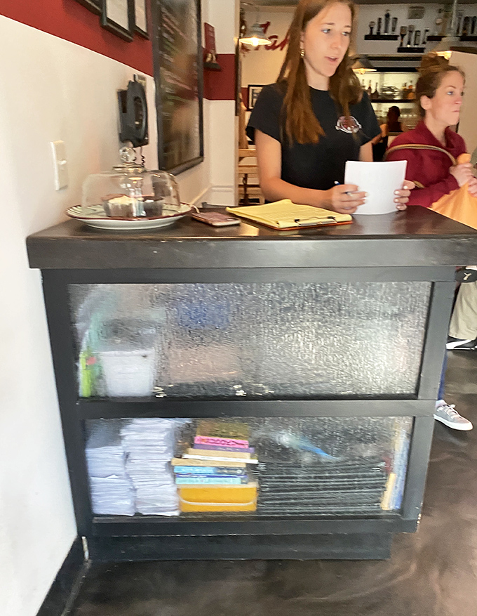 The host station: first checkpoint on your journey to burger nirvana. That glass panel has witnessed countless hungry expressions turn to anticipation.