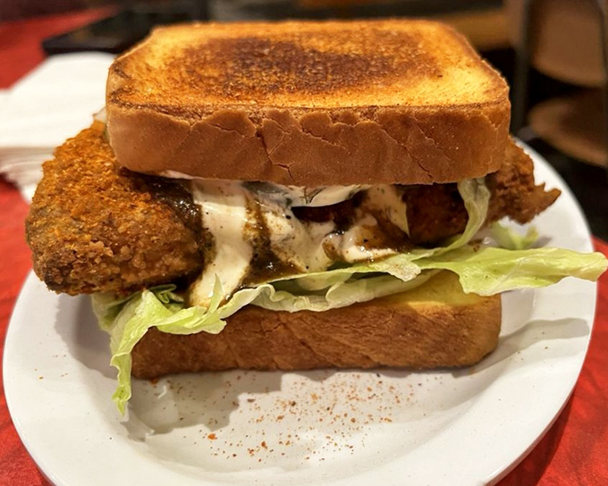 The hot chicken sandwich that makes you sweat and smile simultaneously. Between two slices of Texas toast lies a beautiful kind of delicious pain.