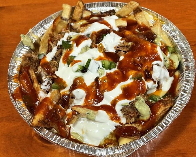 What happens when fries, pulled pork, cheese, and sauce have a party? This glorious mess that requires no manners, just appreciation.