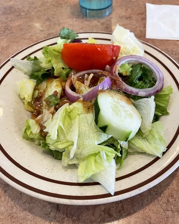 A house salad that actually deserves applause&mdash;crisp, colorful, and fresh. Even vegetable skeptics might be converted by this vibrant plate.