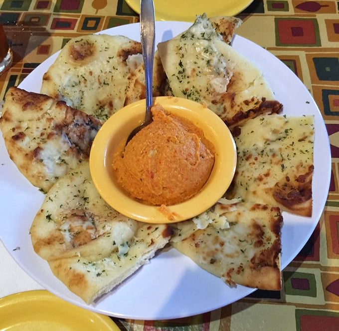 Warm pita bread surrounds hummus like a delicious edible fortress, because sometimes you need appetizers that double as art projects.