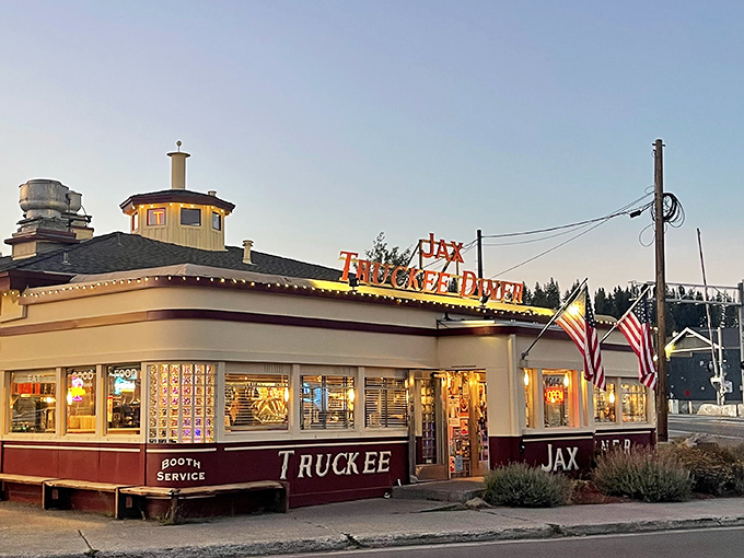 Jax at the Tracks glows at dusk, its vintage diner charm promising comfort food classics in an authentic 1940s railroad dining car.