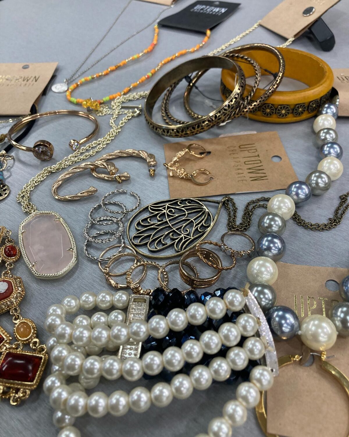 Jewelry that whispers "I found this at an exclusive boutique" while your bank account silently thanks you. Pearl strands and statement pieces await their new homes.