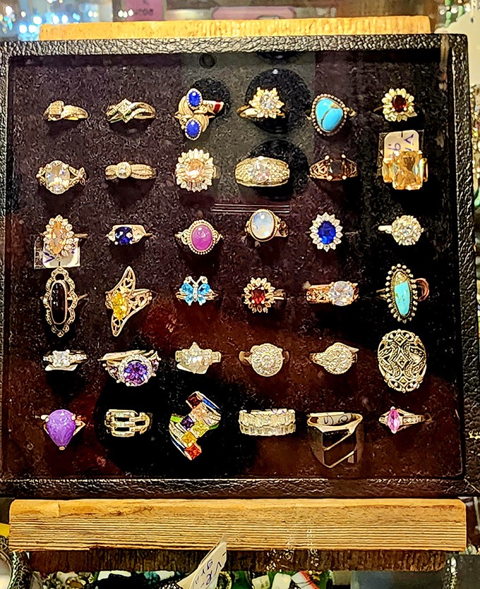 A treasure chest of vintage rings sparkles under glass – each one representing someone's special moment, now waiting for its second act.