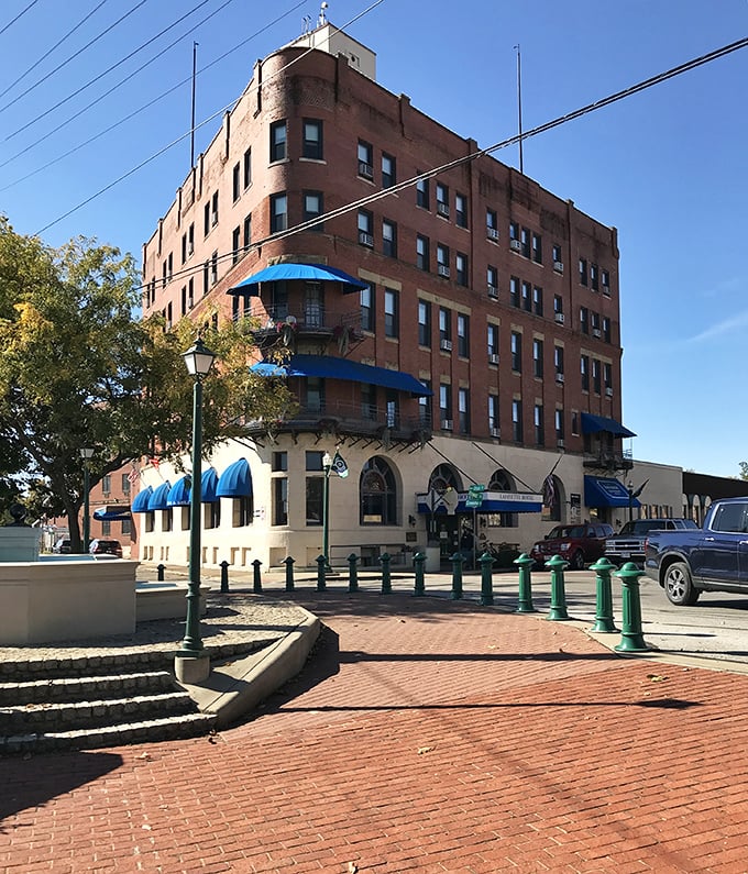 The Lafayette Hotel stands as Marietta's grand dame of hospitality, her blue awnings fluttering like welcome flags to river-weary travelers.