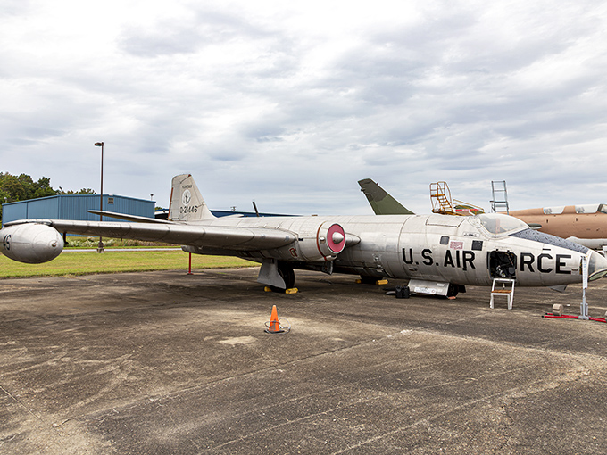 The Martin RB-57A Canberra reconnaissance aircraft stretches out on the tarmac, its distinctive long wings designed for high-altitude surveillance missions. 