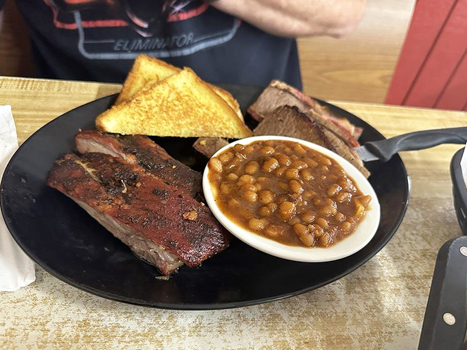 A plate that tells the whole story: smoke ring, bark, tender meat, and sides that know their supporting role but still shine bright.