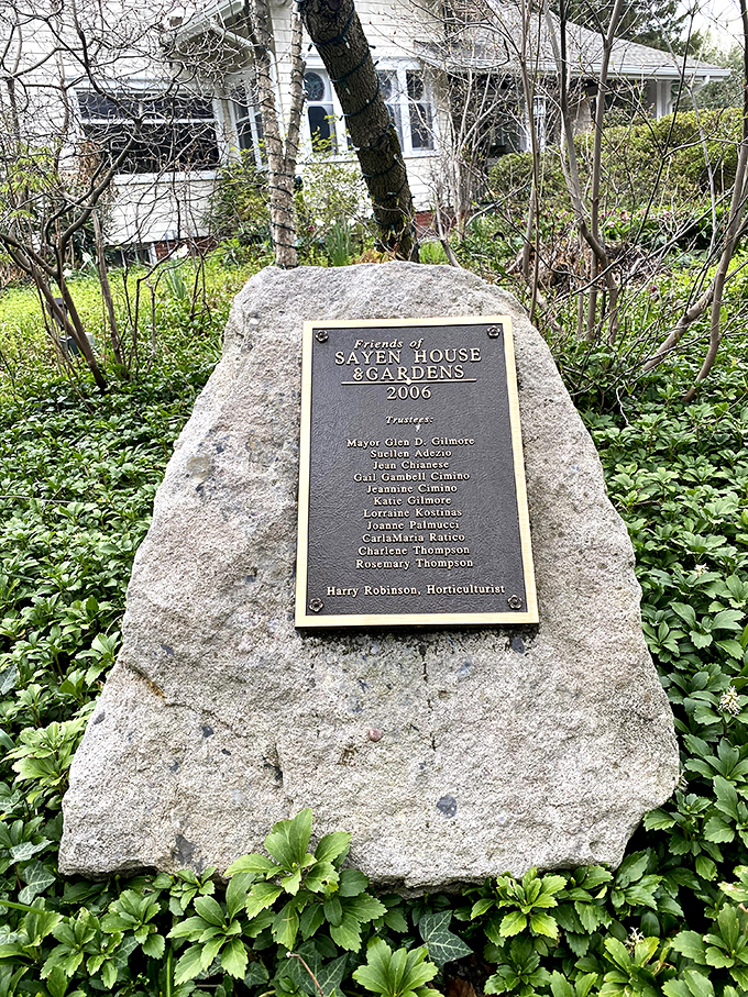 A stone memorial stands as testament to those who preserved this green oasis&mdash;heroes who fought development with daffodils.