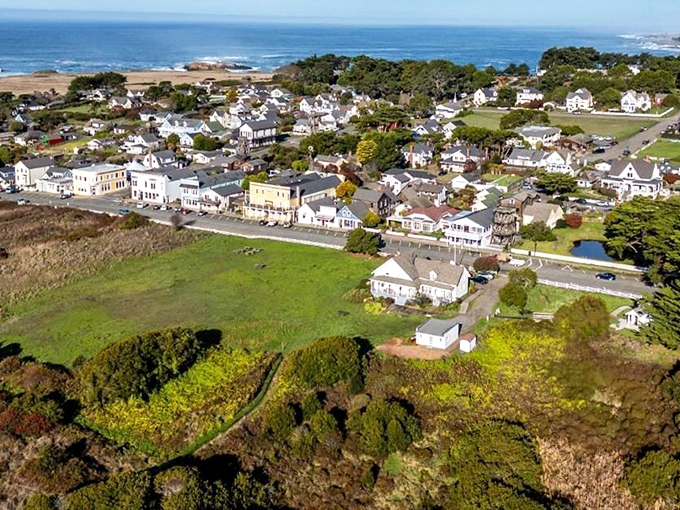 From above, Mendocino reveals its perfect positioning &ndash; a village of white buildings perched between emerald headlands and the endless blue Pacific.