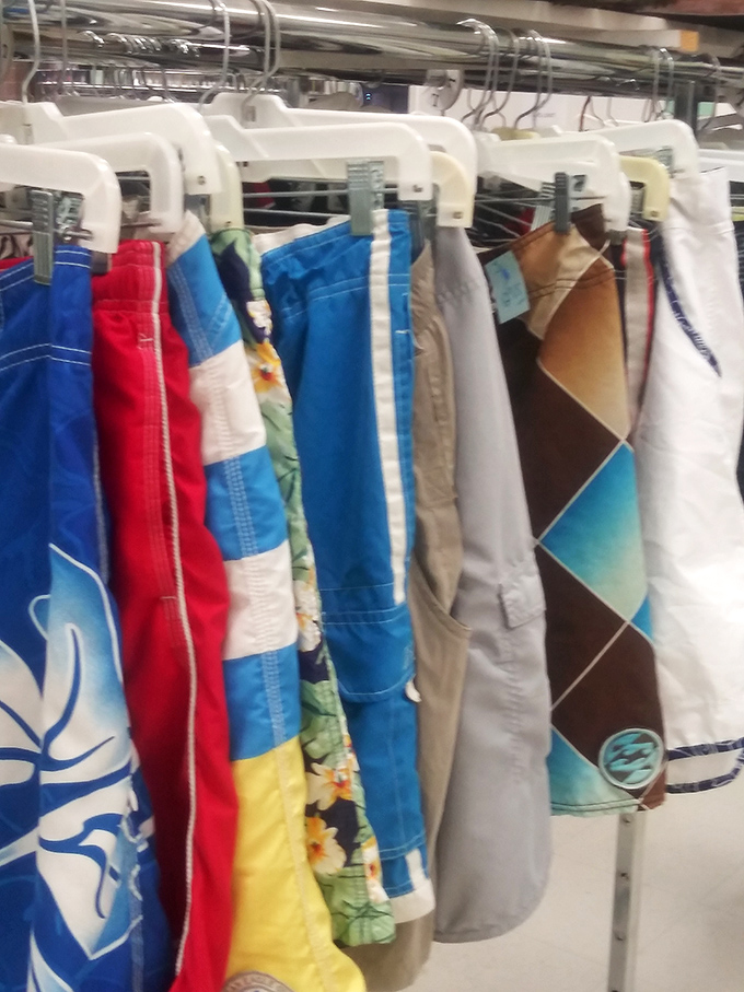 Beach-ready board shorts hanging like tropical flags, each pattern telling tales of summers past and ocean adventures to come.