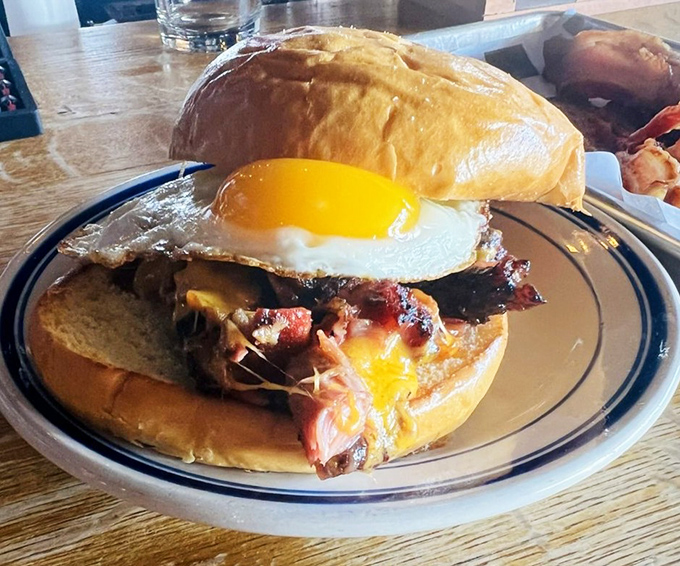 Breakfast sandwich or work of art? The runny egg yolk creates a natural sauce for the smoky meat below. Morning glory on a bun.