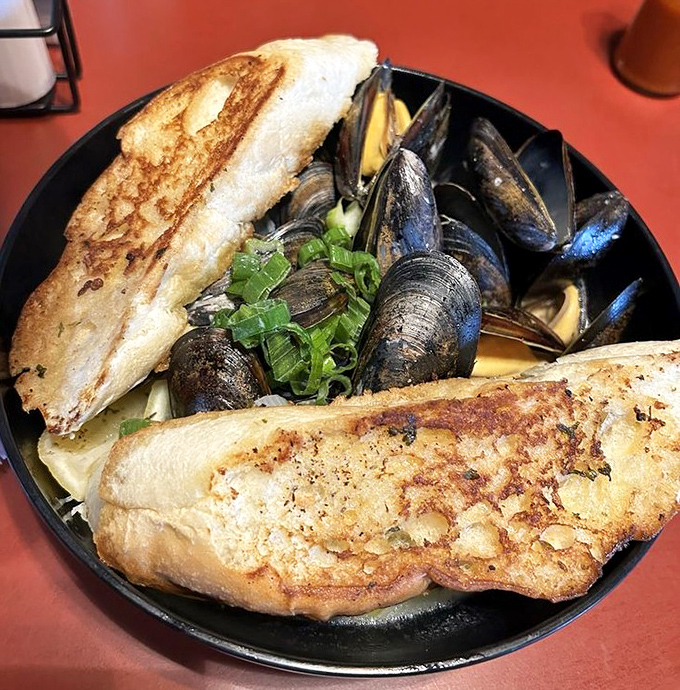 Mussels that mean business, swimming in broth worth sopping up with every last crumb of that grilled bread. Maritime magic in a bowl.