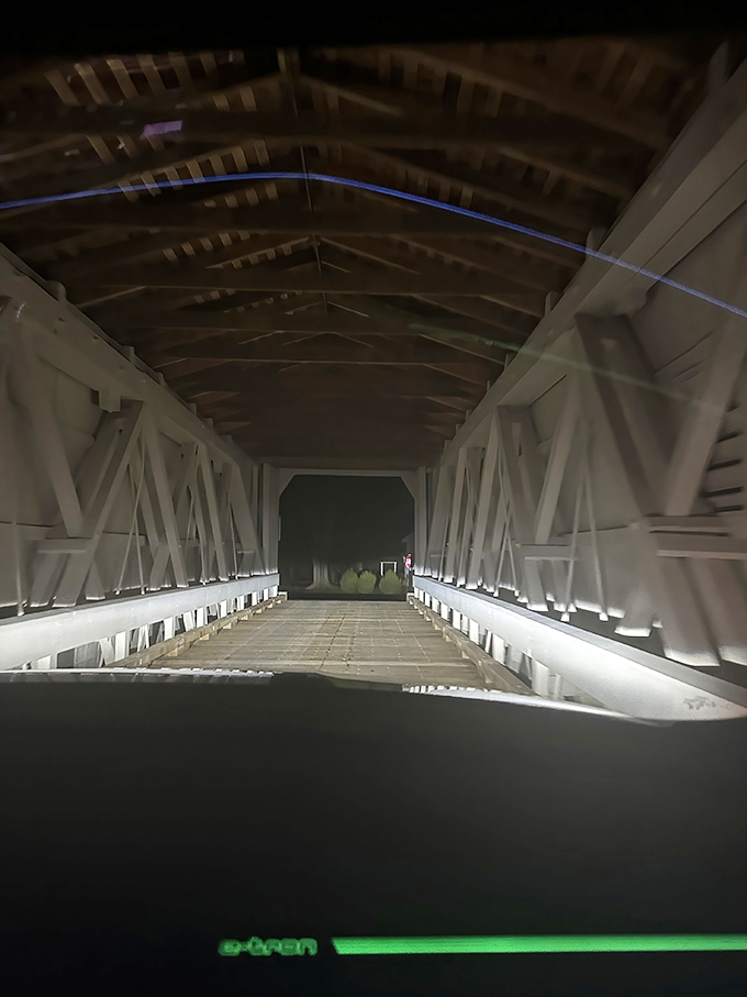 After dark, headlights illuminate the wooden cathedral-like interior, creating an almost mystical passage through time.