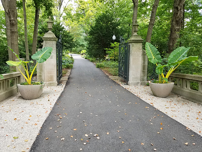 Grand stone pillars and tropical plants create an entrance that says, "Yes, you've arrived somewhere special," even if you're just wearing your weekend athleisure.