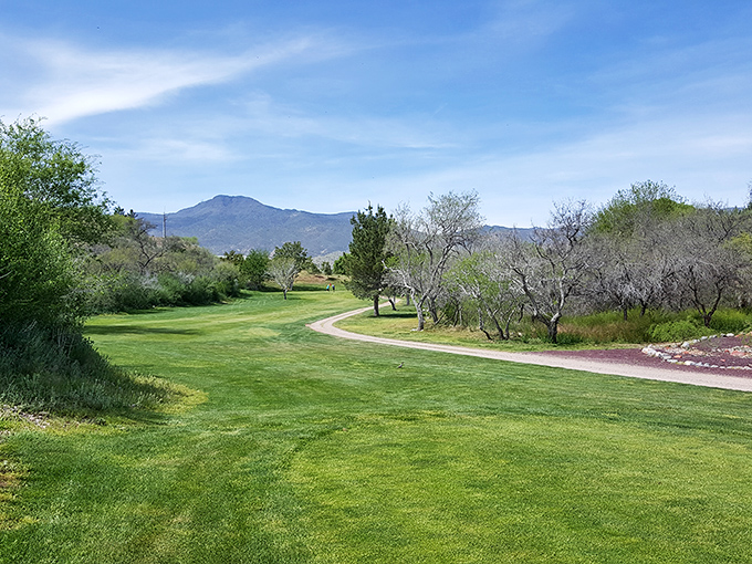 Golf greens stretch toward mountain vistas, proving that paradise comes with reasonable green fees and stunning views.