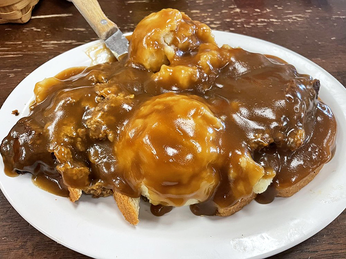 Open-face meatloaf drowning in rich brown gravy &ndash; the kind of dish that makes you want to hug the chef. Comfort food that speaks directly to the soul.