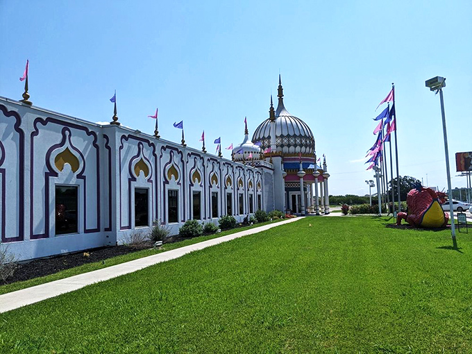 The side view reveals just how massive this oddity palace truly is. Those pink and blue flags flutter like they're celebrating weirdness itself. 